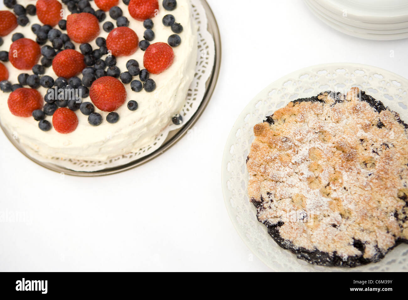Strawberry blueberry cake and blueberry crumble on dessert table Stock ...