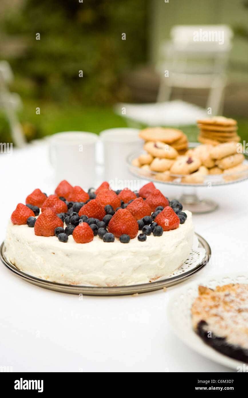 Strawberry blueberry cake on dessert table Stock Photo - Alamy