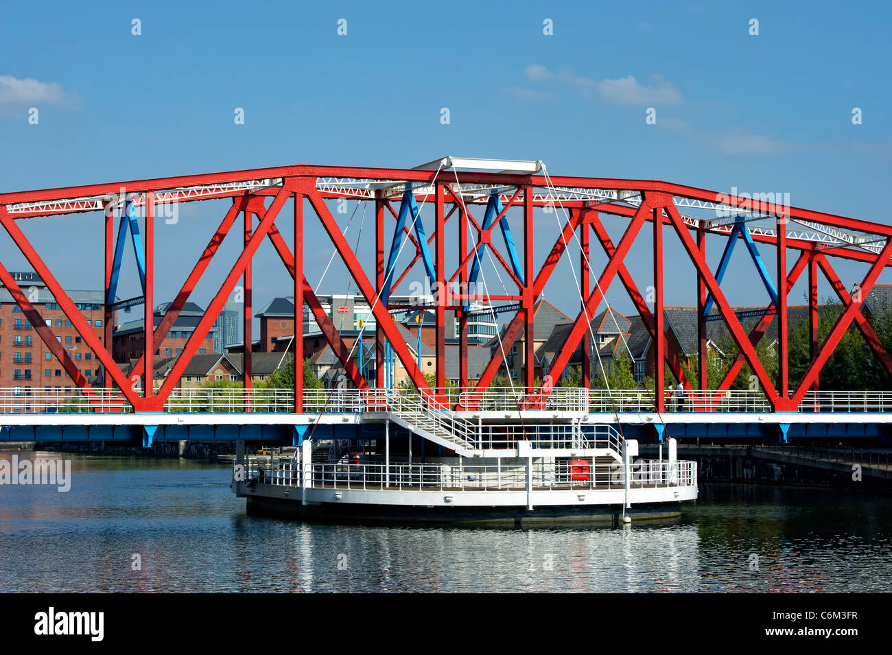 Red, white and blue bridge spanning one of the docks in Salford Quays ...