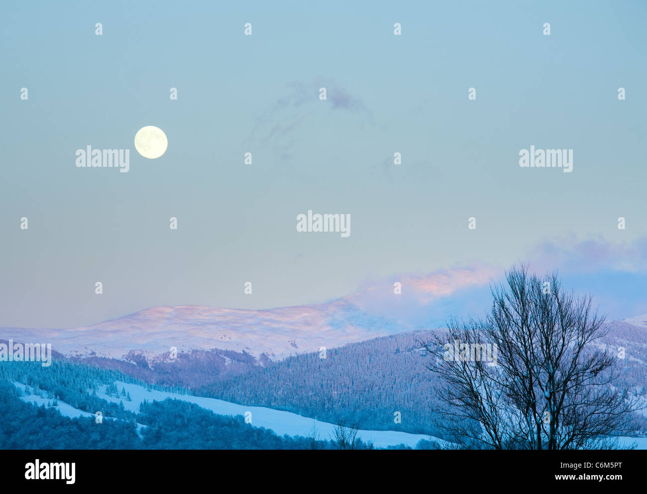 winter sunset mountain landscape with rime and snow covered forest and ...