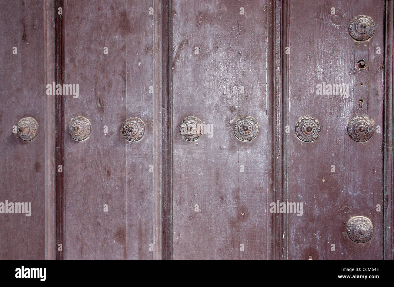 Close-old wooden door with metal tacks handmade Stock Photo - Alamy