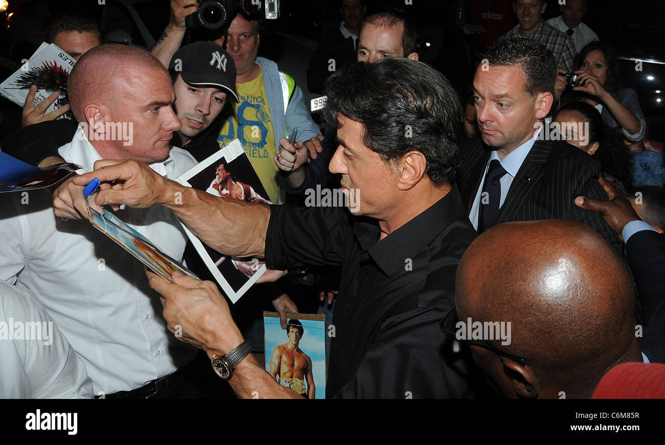 Sylvester Stallone is mobbed by autograph hunters as he arrives back at ...
