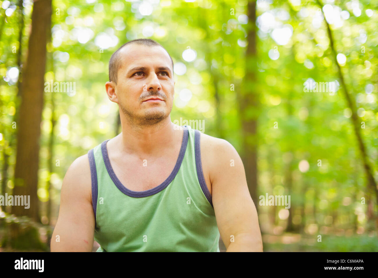 Closeup portrait of a fit young man outdoor in the forest Stock Photo ...