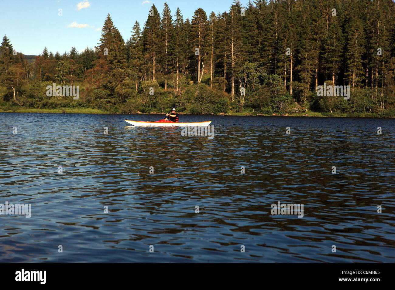 Kayaker on Loch Ard in the Trossachs with the Queen Elizabeth Forset ...