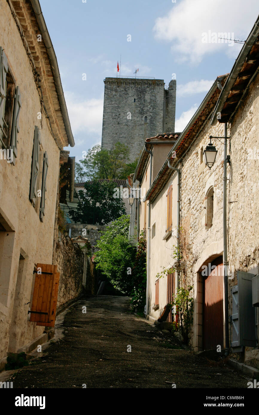 Narrow street in the small French town Montcuq-De-Quercy leading up to ...
