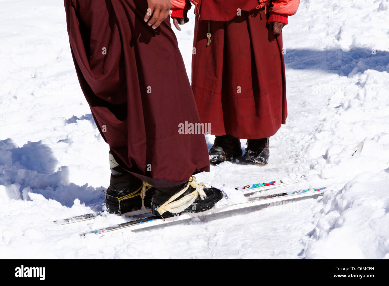 Buddhist monks skiing in the snow at the Tengboche Monastery, Everest ...