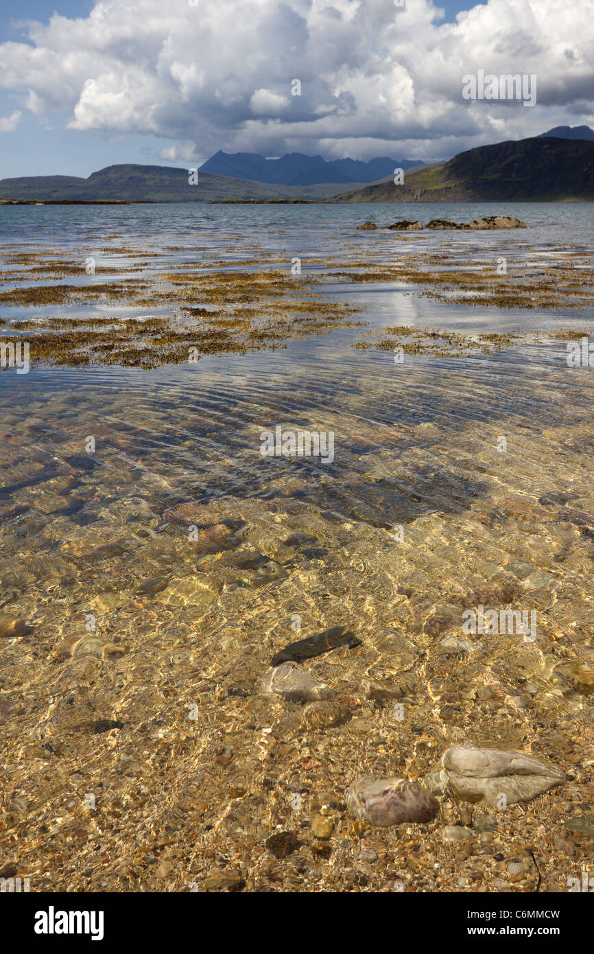 Shallow shoreline waters of Loch Eishort with Black Cuillin mountains ...