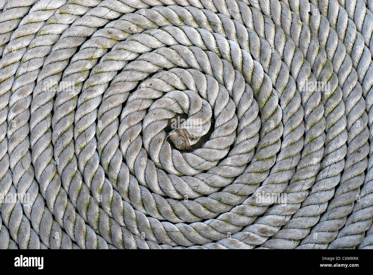 Thick rope wrapped in a spiral on the ship's deck Stock Photo - Alamy