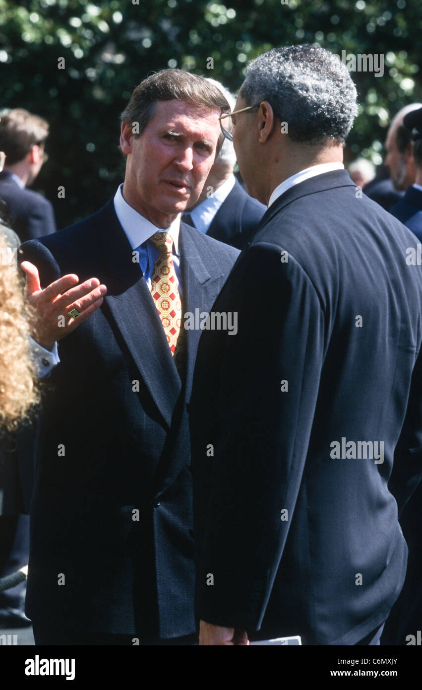 Defense Secretary William Cohen speaks with Gen. Colin Powell during a ...