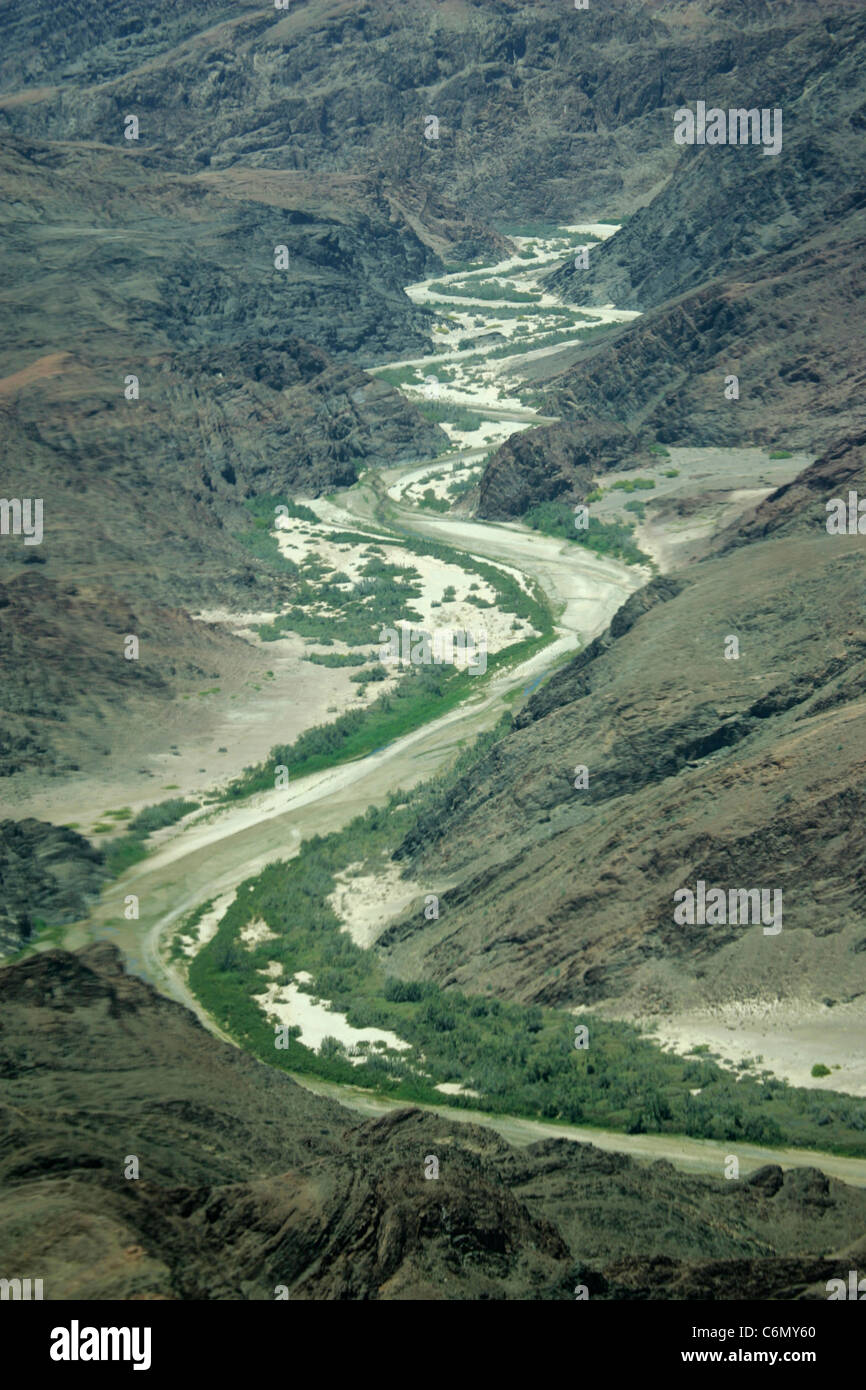 An aerial view of a stream weaving through a valley Stock Photo - Alamy
