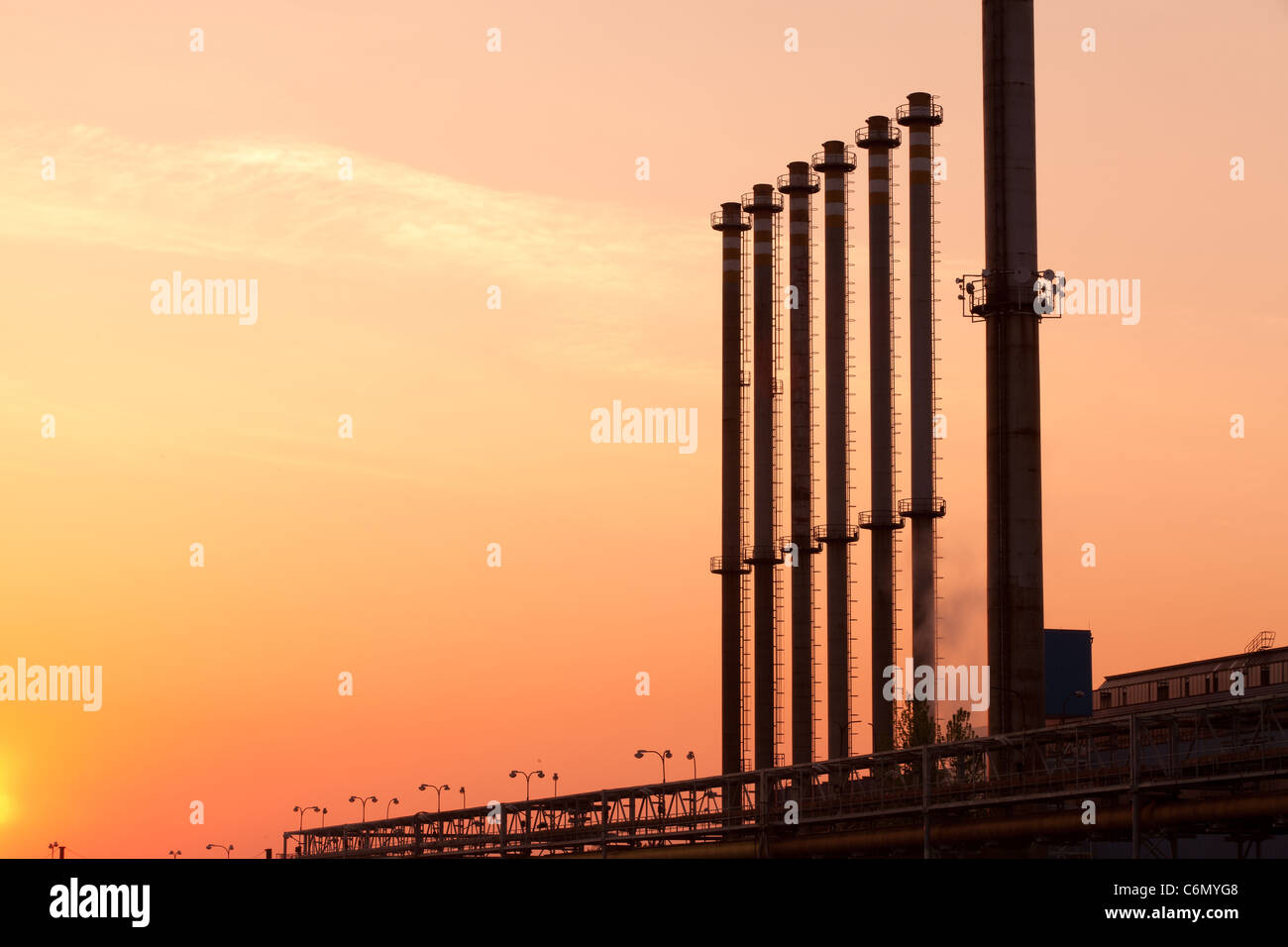 Factory chimneys at sunrise Stock Photo - Alamy