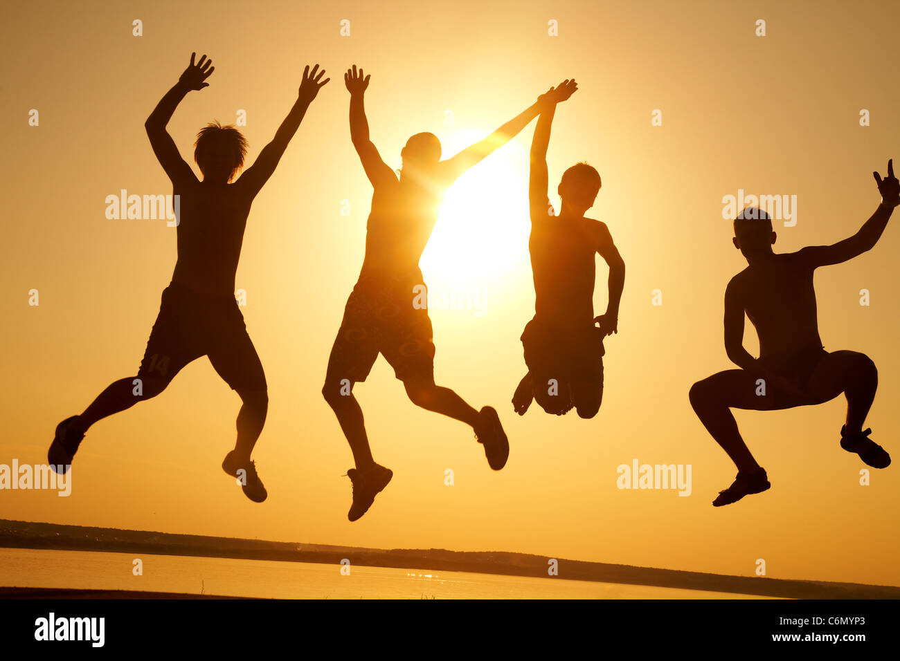 group of happy young people dancing at the beach on beautiful summer ...