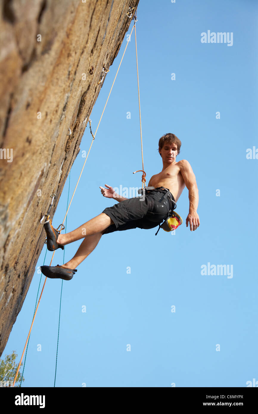 rock climber climbing an overhanging cliff against the blue sky Stock ...