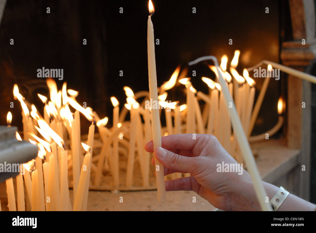 People lighting prayer candles outside a Greek church Stock Photo - Alamy