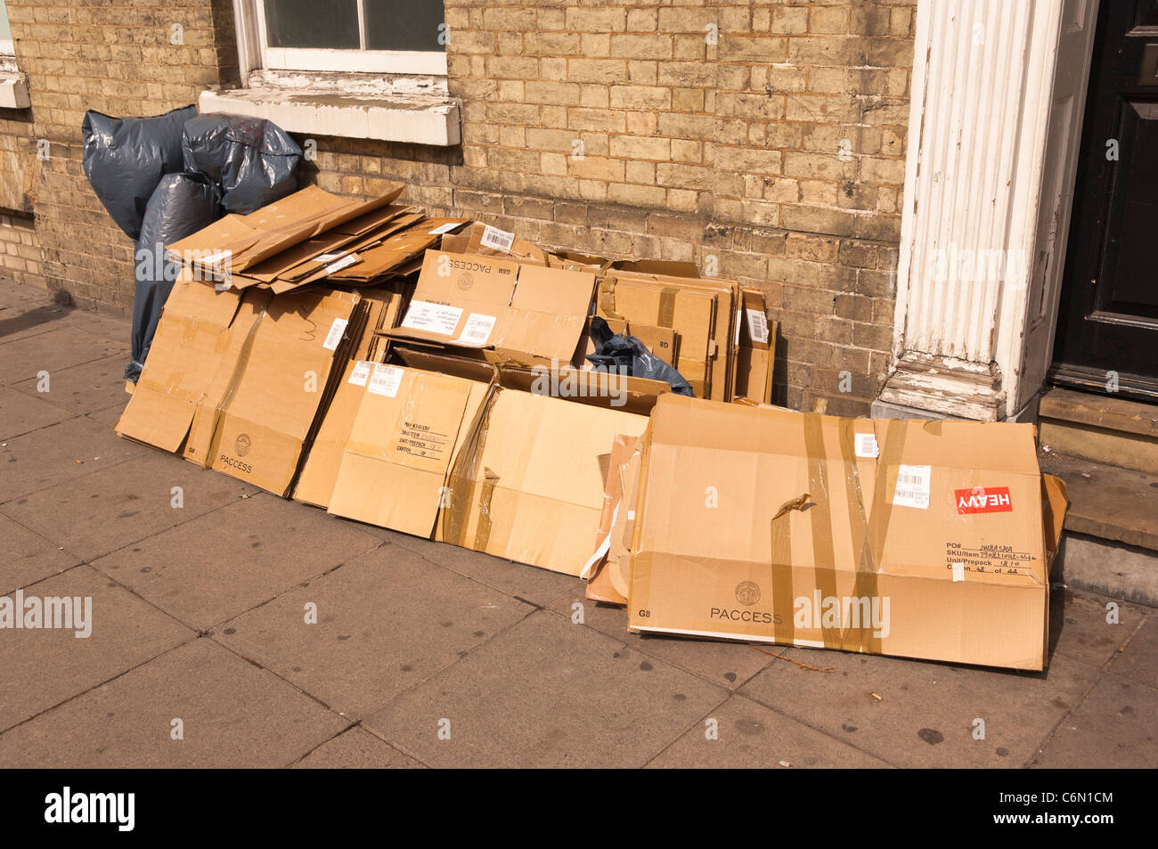 Folded up cardboard boxes ready to be recycled outside a Uk shop Stock ...