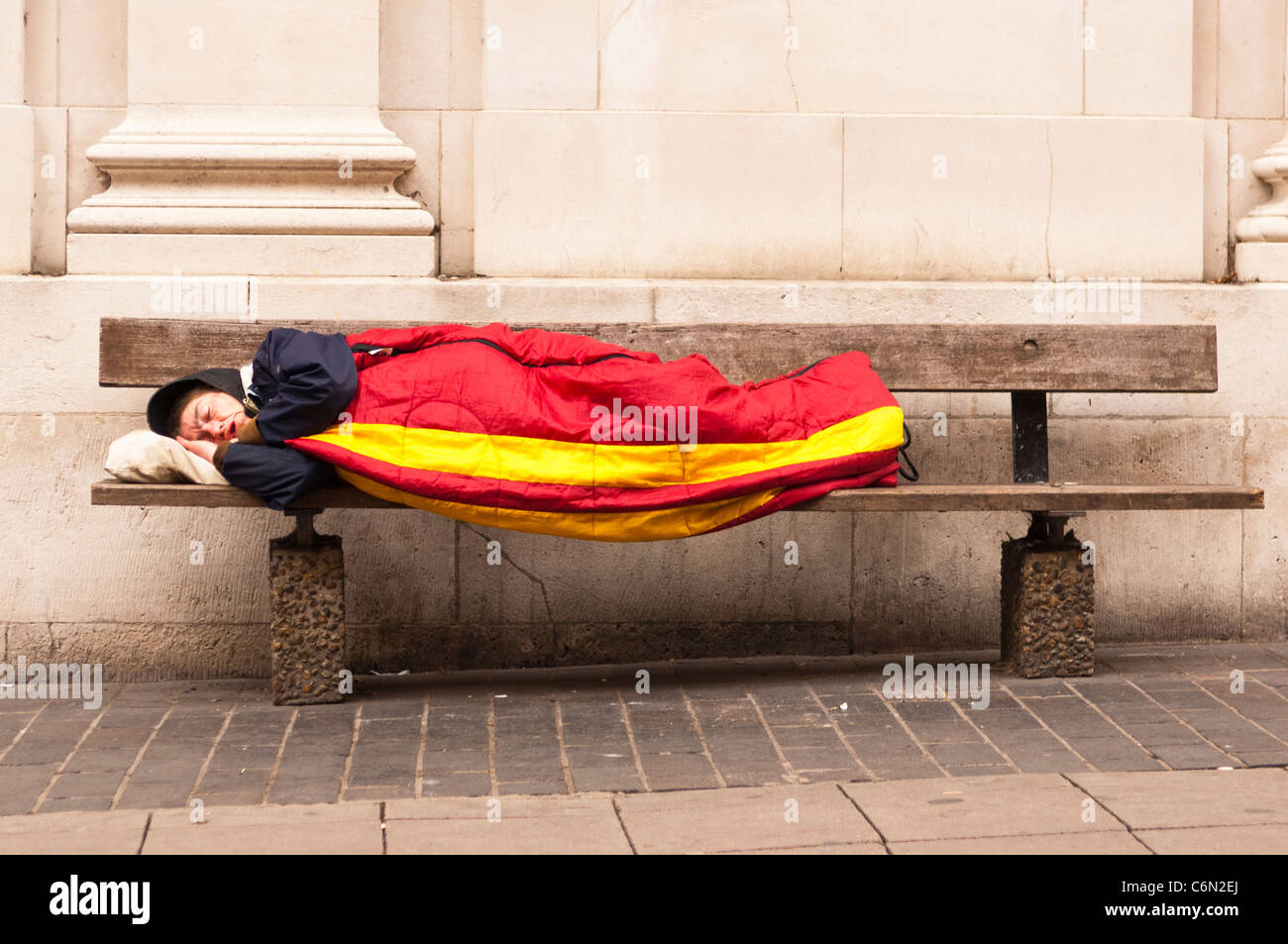 A homeless person sleeping rough on a bench in Norwich , Norfolk ...