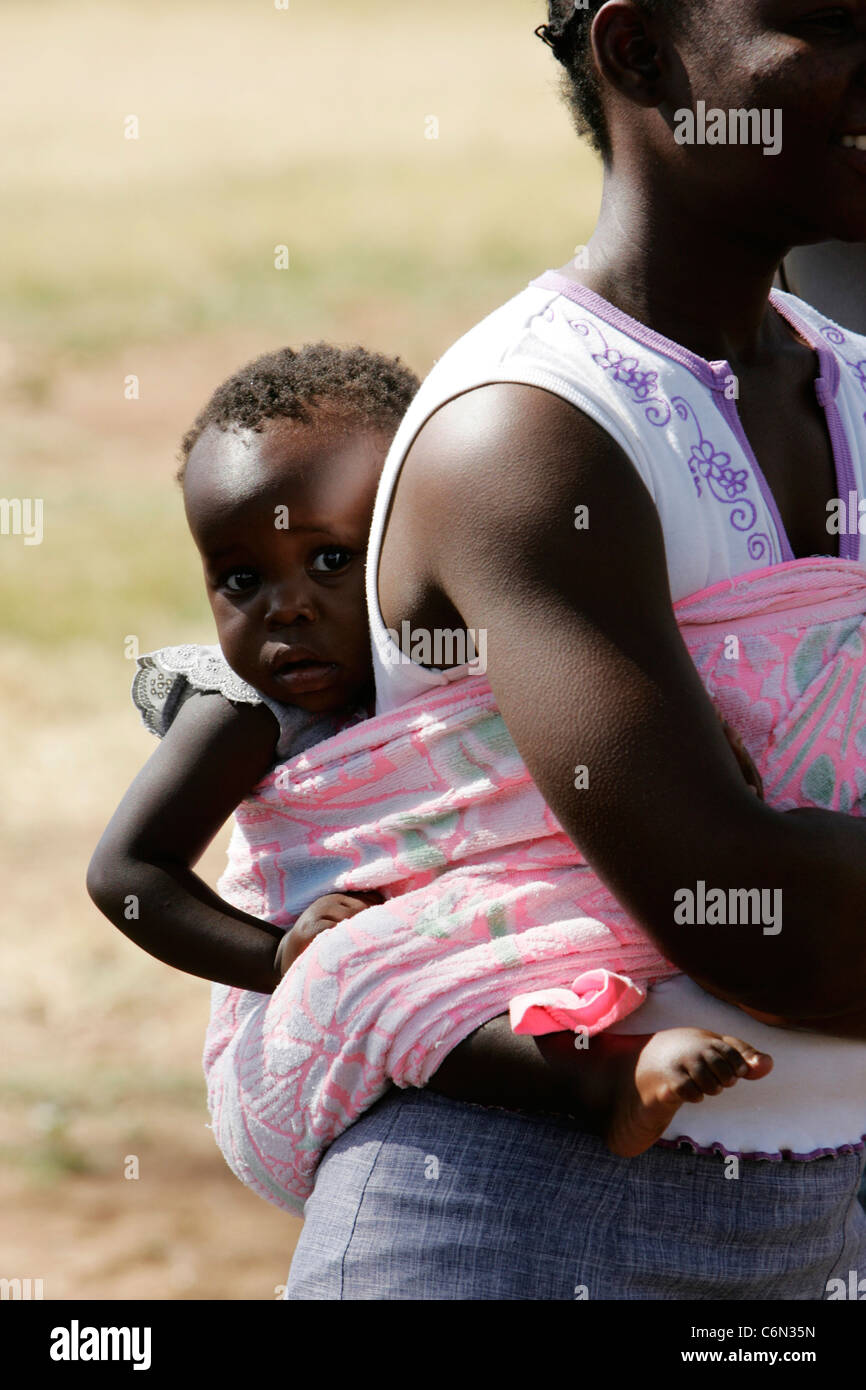 Woman carrying her child on her back hi-res stock photography and ...