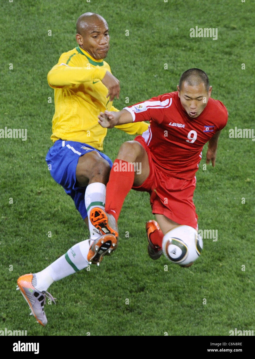 Brazilian defender Maicon (L) fights for the ball with North Korean ...