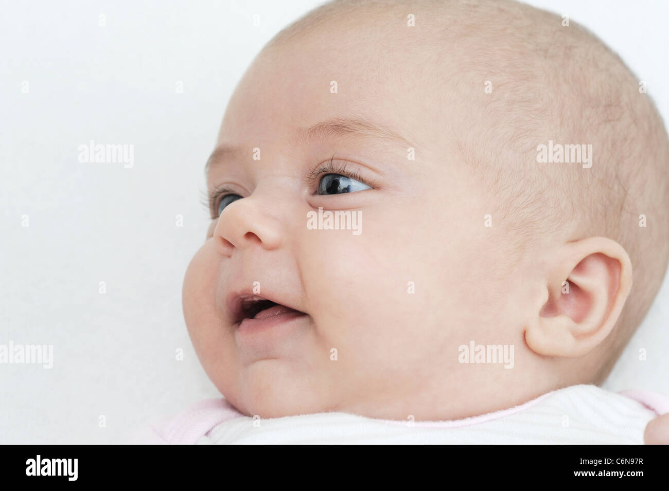 profile of smiling newborn with blu eyes on white background Stock ...