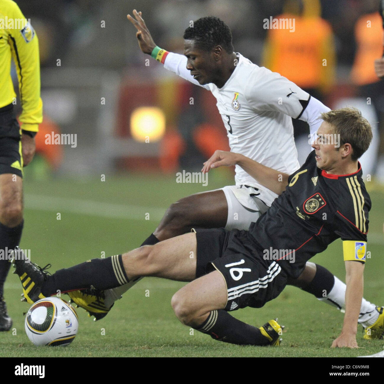 Germany defender Philipp Lahm (16) and Ghana striker Asamoah Gyan fight ...