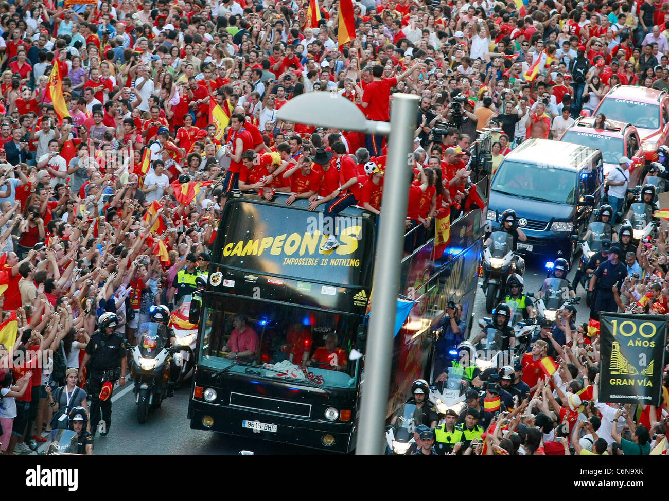 Crowds cheer for the Spanish team as they travel in an open bus as part ...