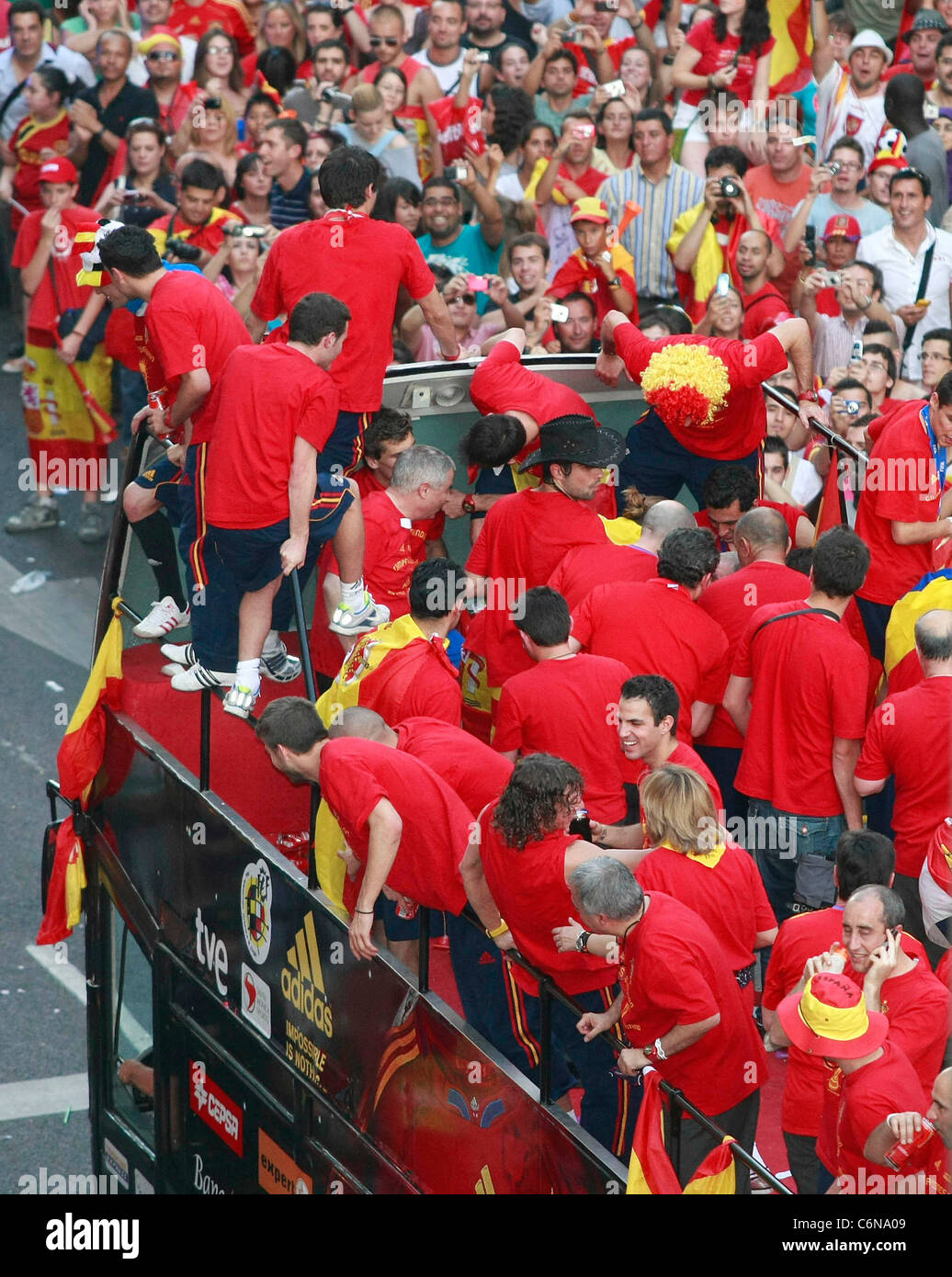 Crowds cheer for the Spanish team as they travel in an open bus as part ...