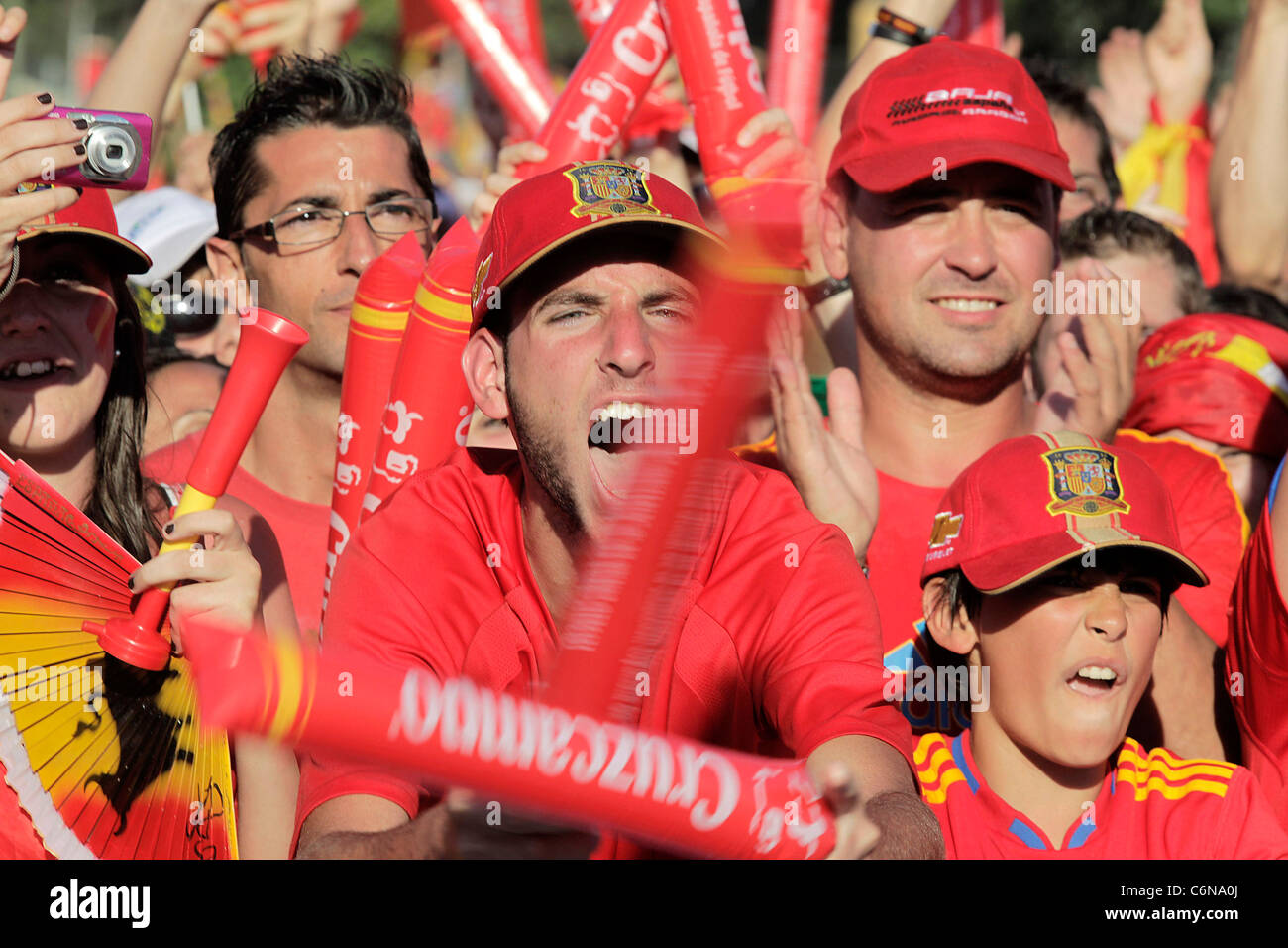 Crowds cheer for the Spanish team as they travel in an open bus as part ...