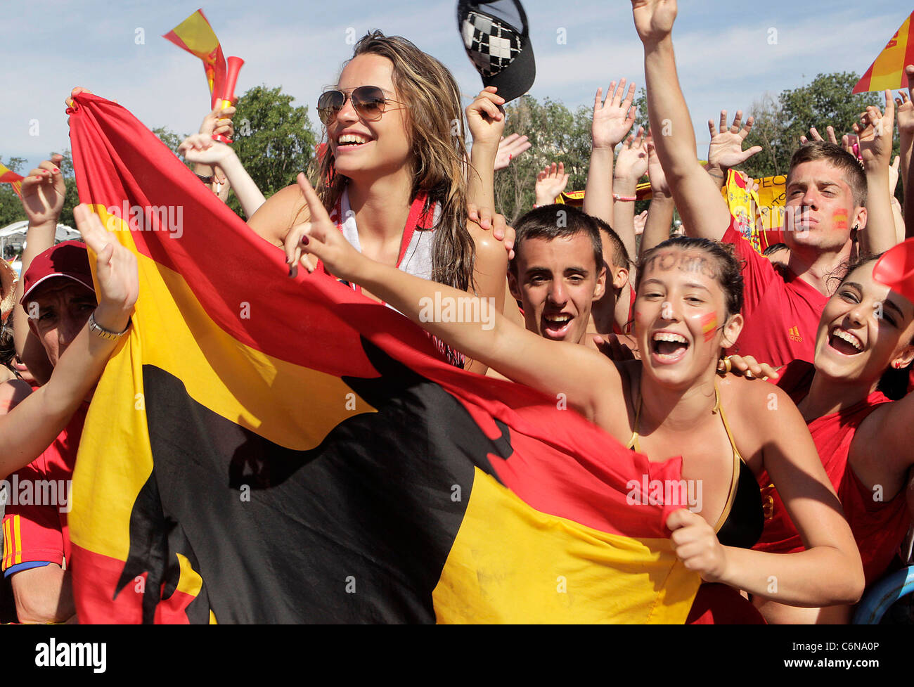 Crowds cheer for the Spanish team as they travel in an open bus as part ...