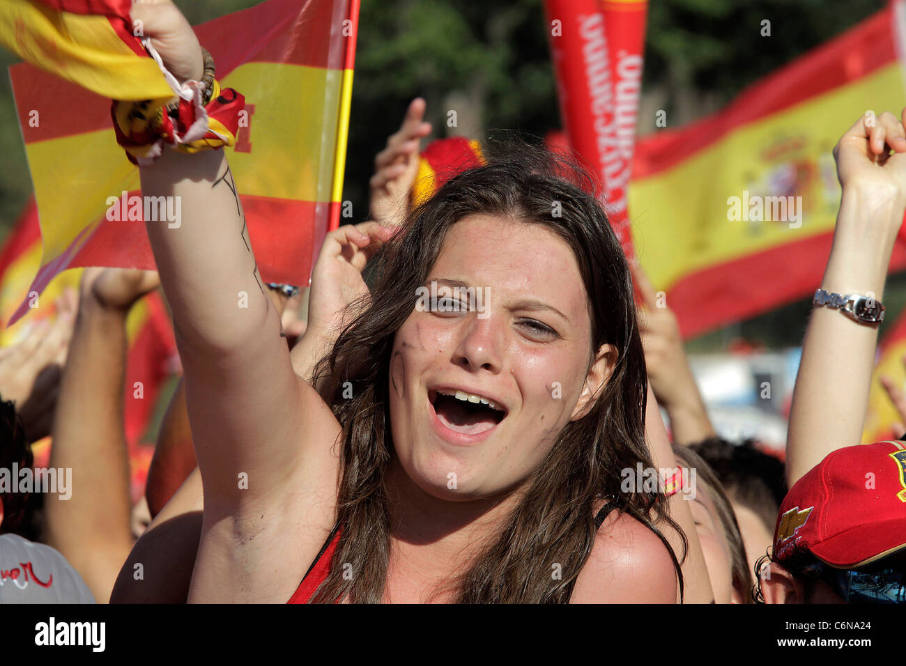 Crowds cheer for the Spanish team as they travel in an open bus as part ...