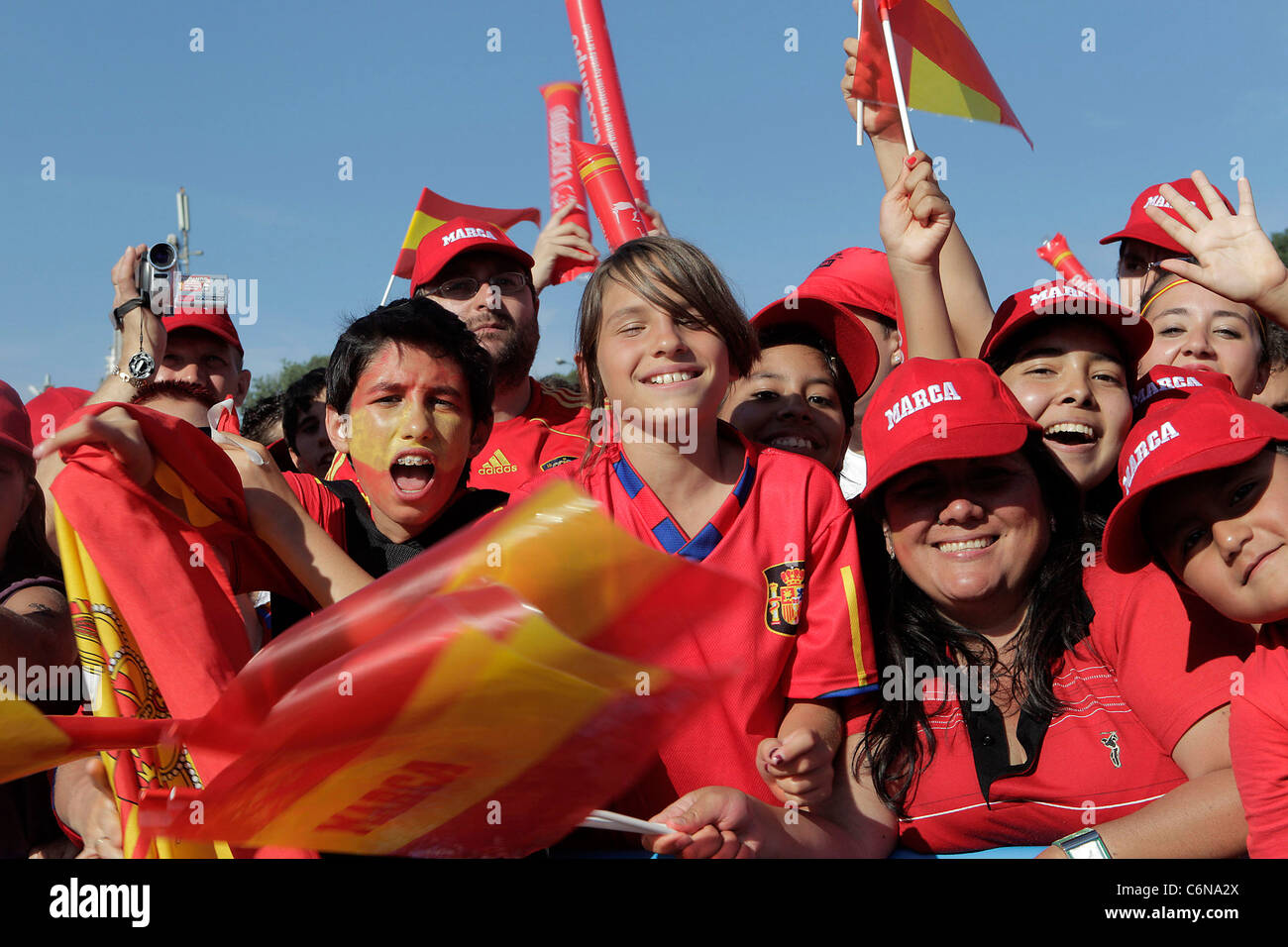 Crowds cheer for the Spanish team as they travel in an open bus as part ...