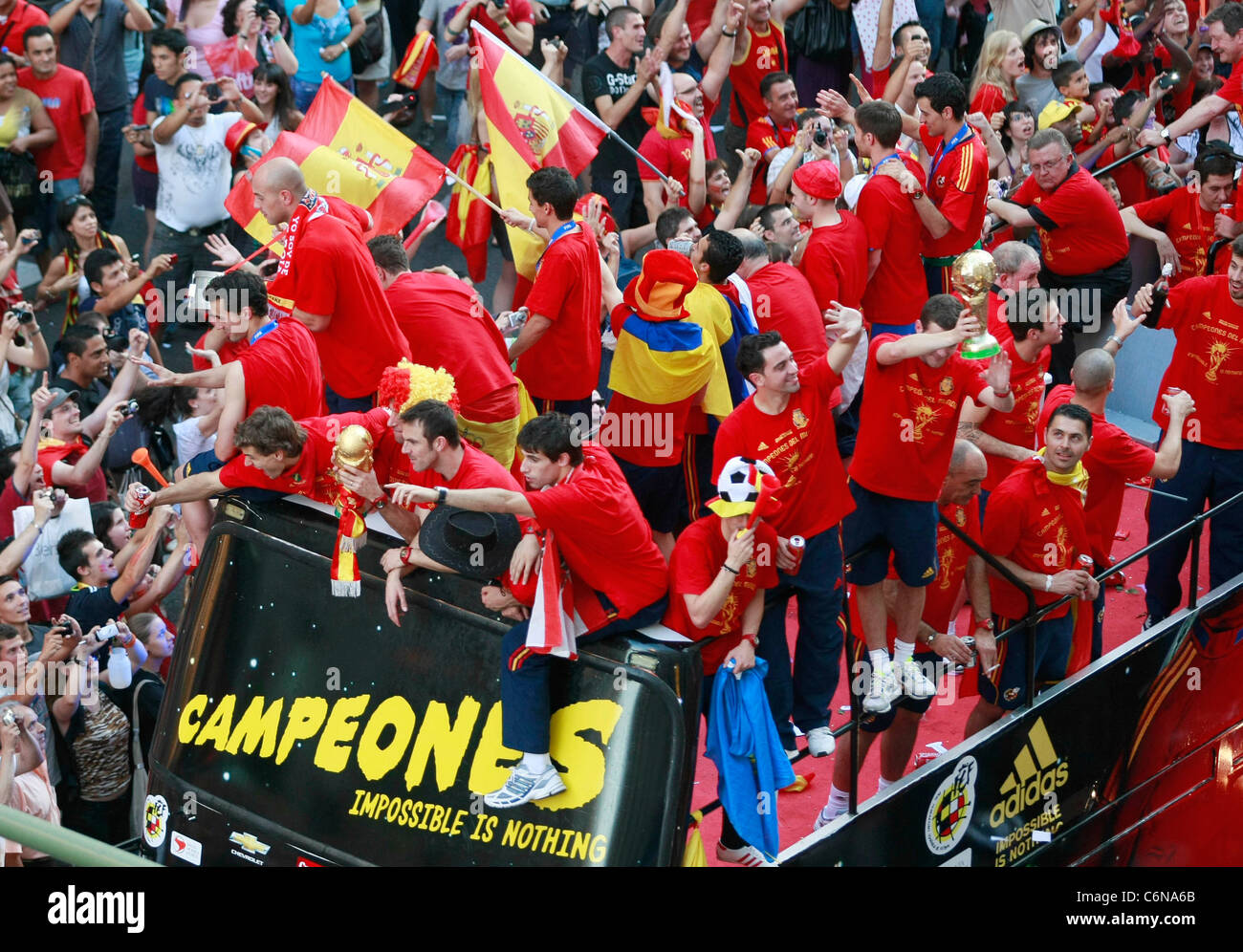 Crowds cheer for the Spanish team as they travel in an open bus as part ...