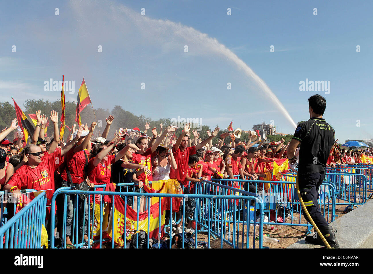 A fireman refresh to the Spain's supporters during of the Spanish team ...