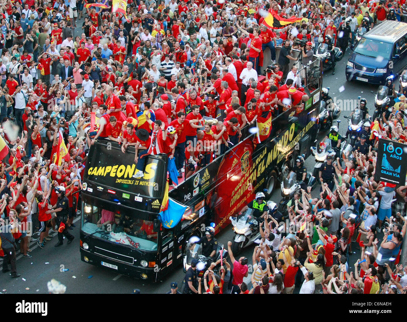 Crowds cheer for the Spanish team as they travel in an open bus as part ...