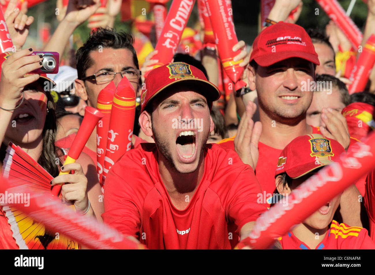 Crowds cheer for the Spanish team as they travel in an open bus as part ...