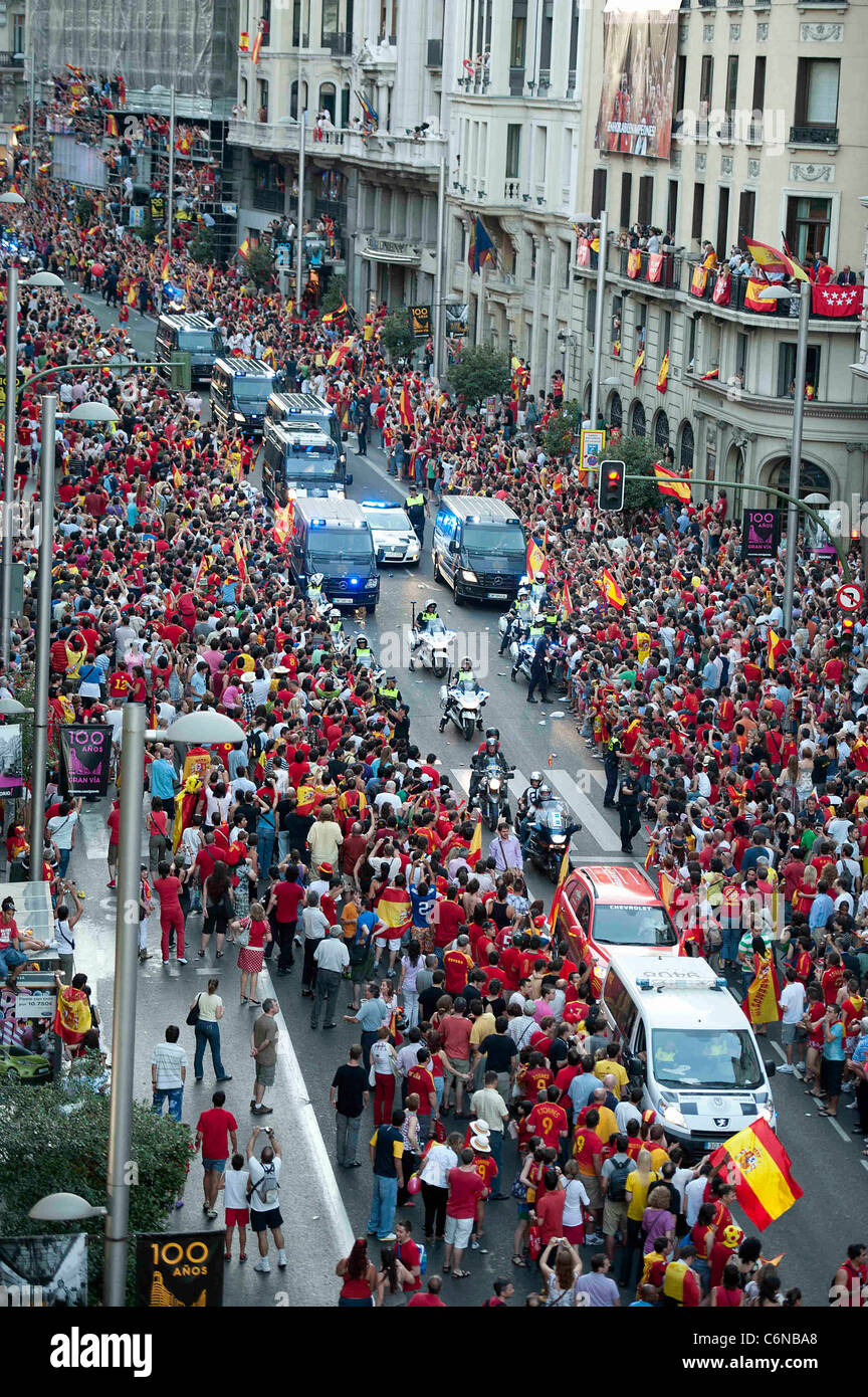 Crowds cheer for the Spanish team as they travel in an open bus as part ...