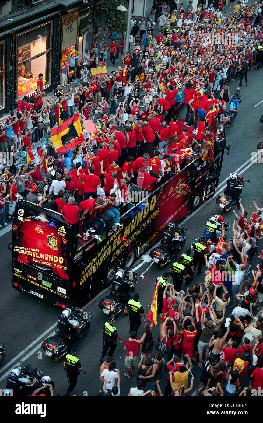 Crowds cheer for the Spanish team as they travel in an open bus as part ...