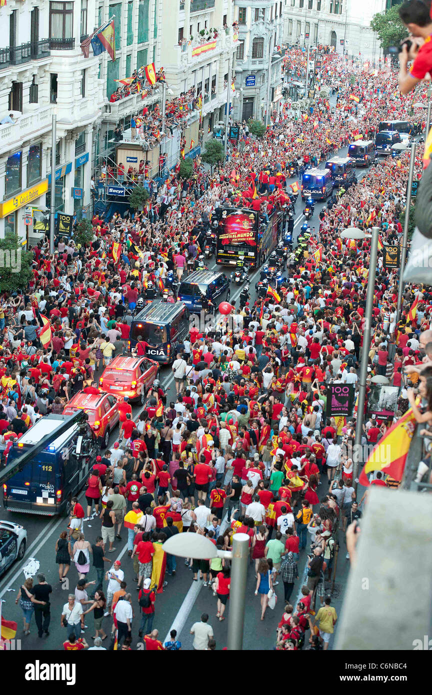 Crowds cheer for the Spanish team as they travel in an open bus as part ...