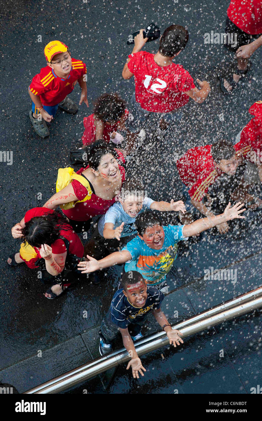 Crowds cheer for the Spanish team as they travel in an open bus as part ...