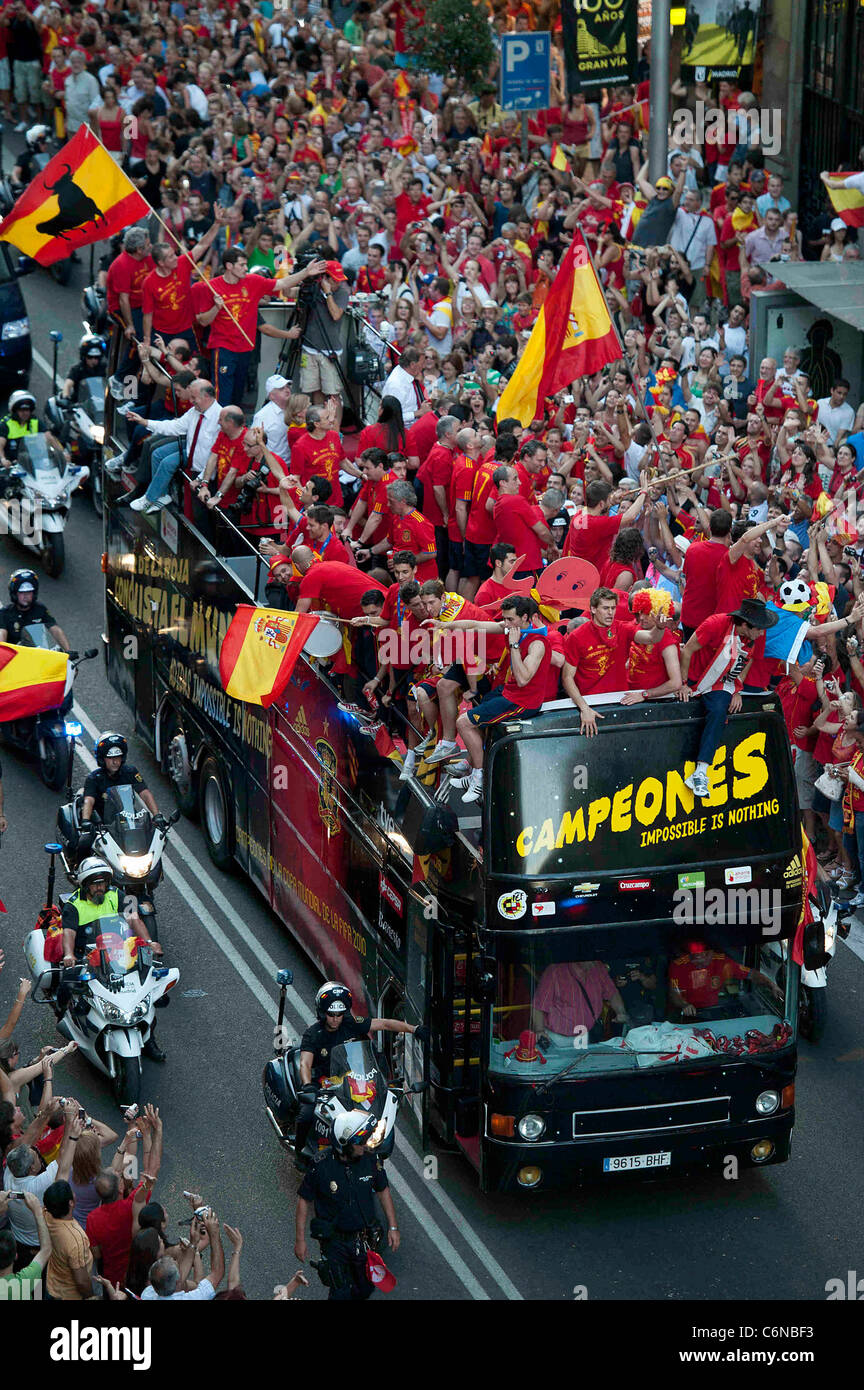 Crowds cheer for the Spanish team as they travel in an open bus as part ...