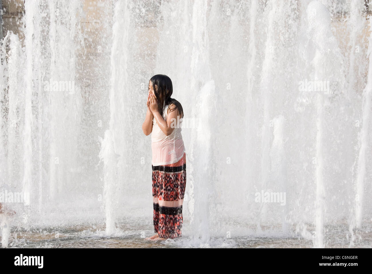 Asian Girl Soaked Through Standing in the Water Jets of the Goodwin Fountain, Peace Gardens ...