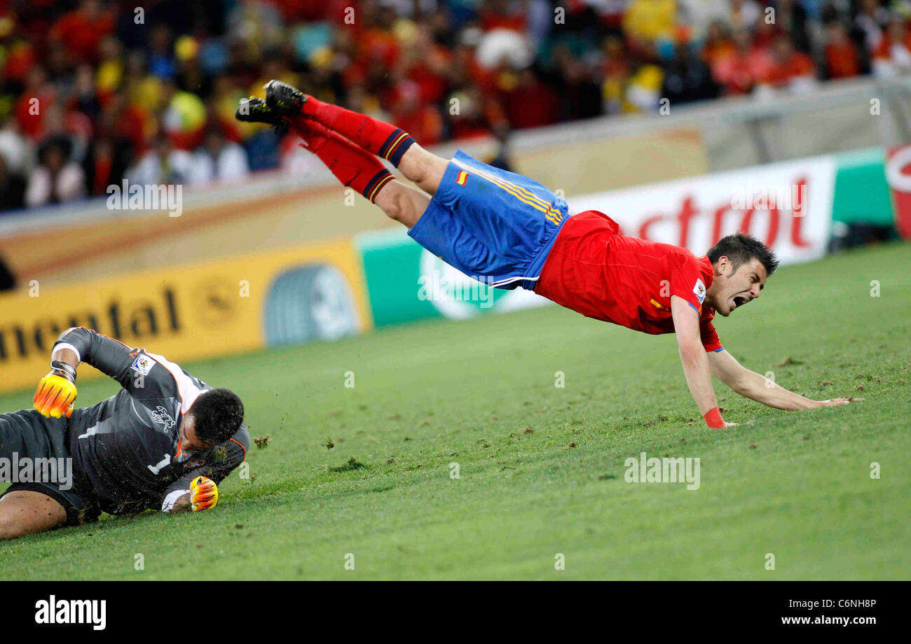 David Villa heads for a nasty bump on the ground during a tackle with ...