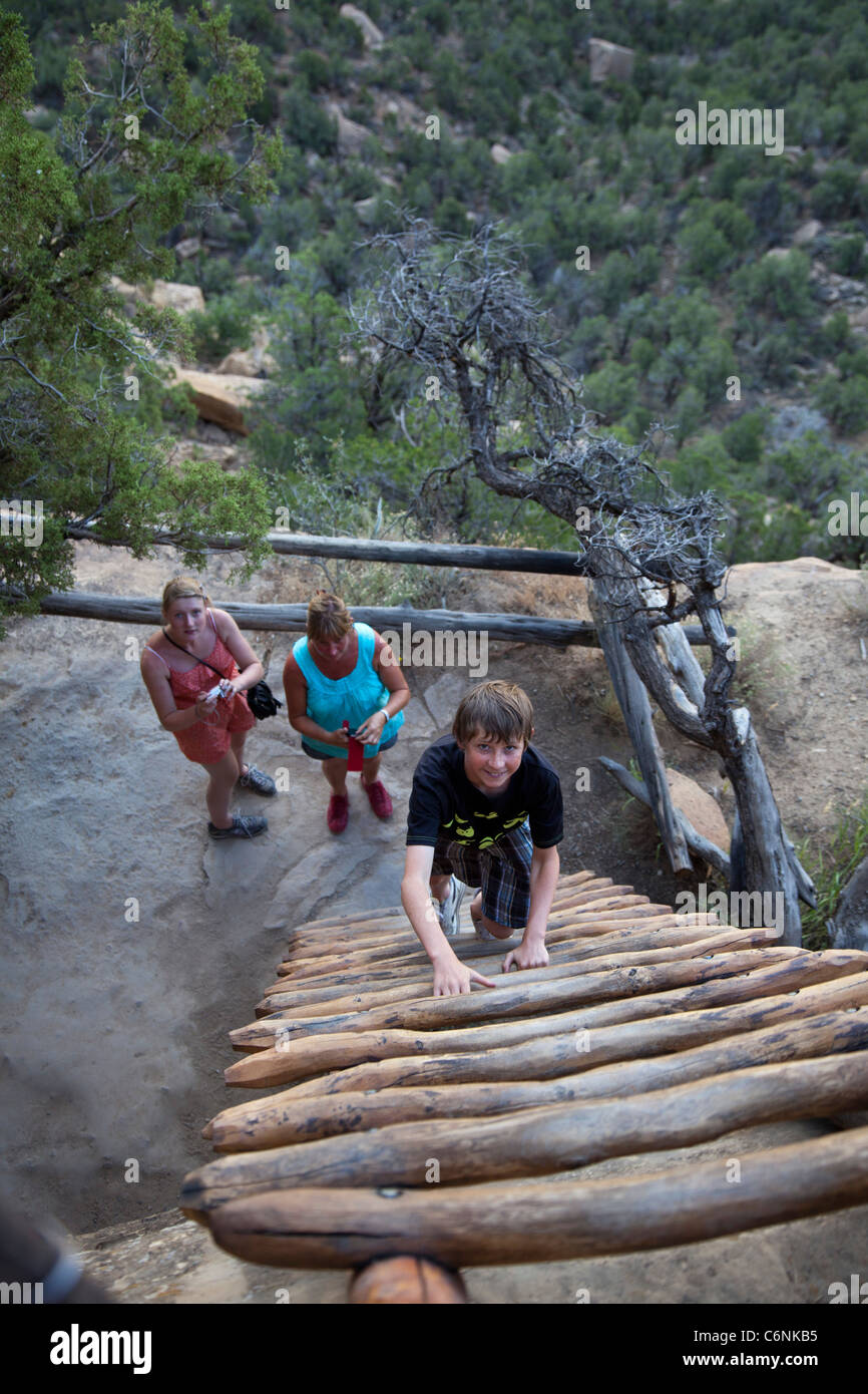 Visitors climb a ladder to leave the Balcony House cliff dwelling at ...