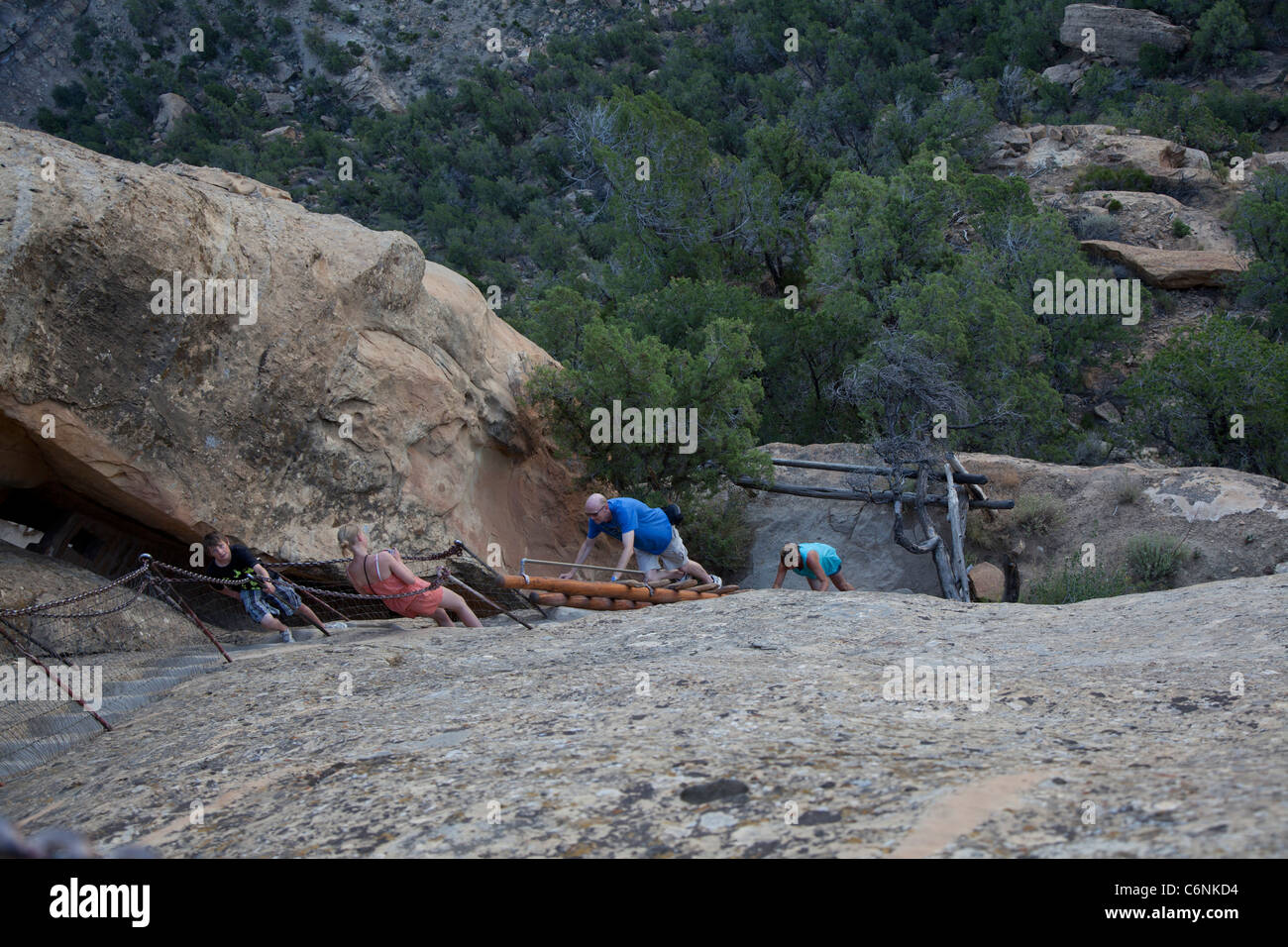 Visitors climb a ladder to leave the Balcony House cliff dwelling at ...