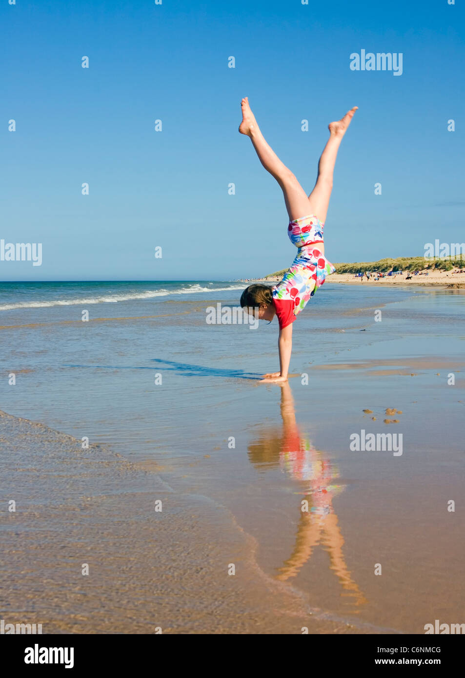 Girl Handstand On The Beach