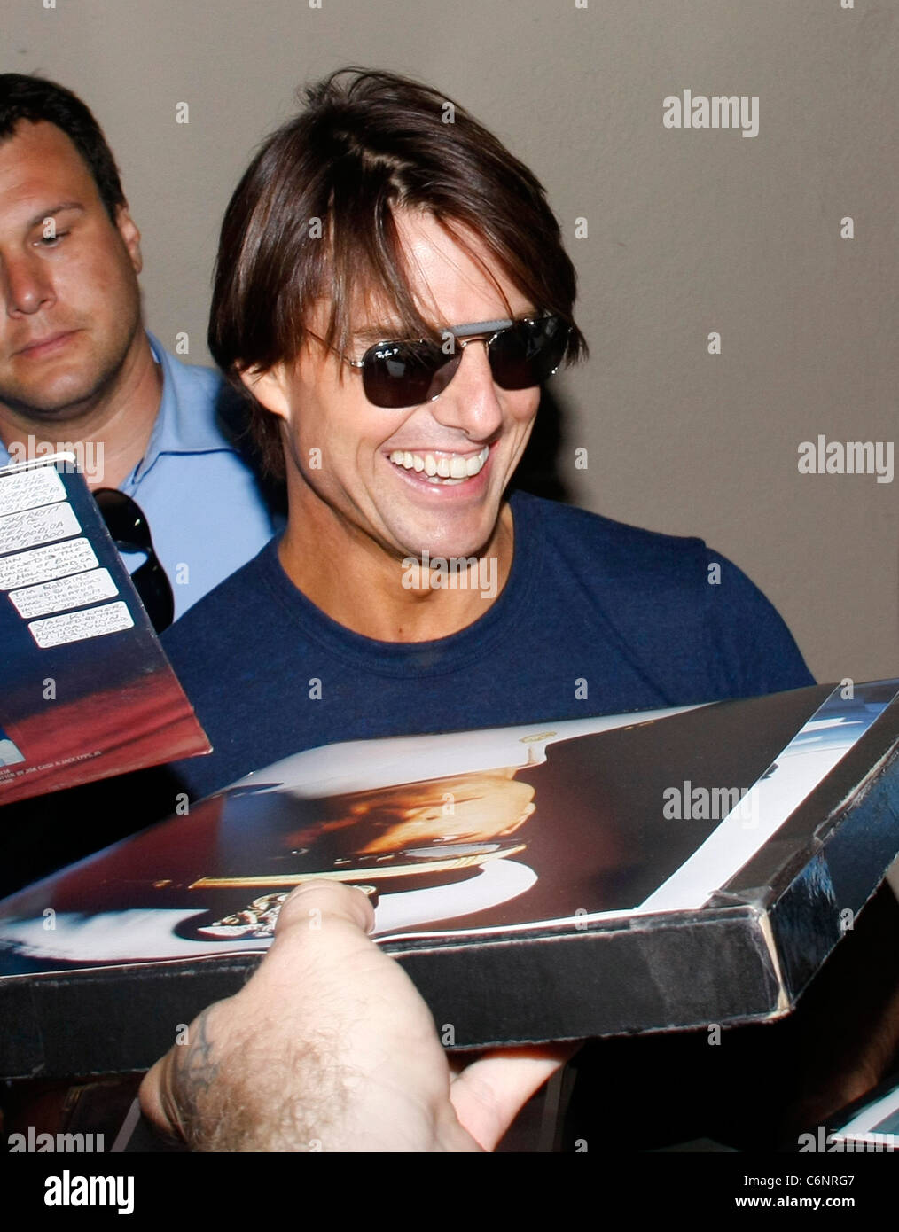 Tom Cruise signs autographs as he leaves the El Capitan Theatre after ...