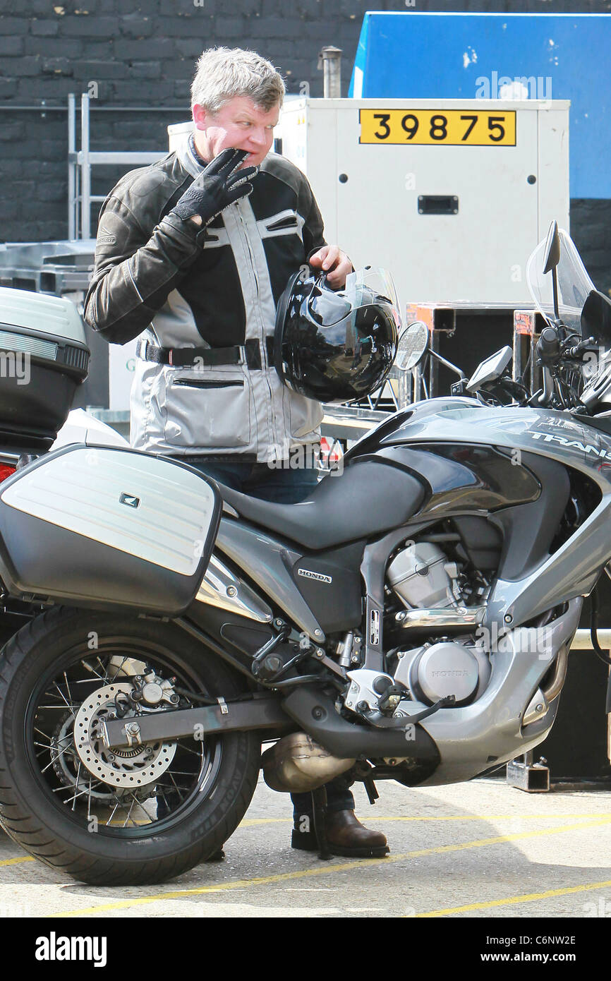 Adrian Chiles Arrives by motorcycle for a photo shoot at a studio in ...