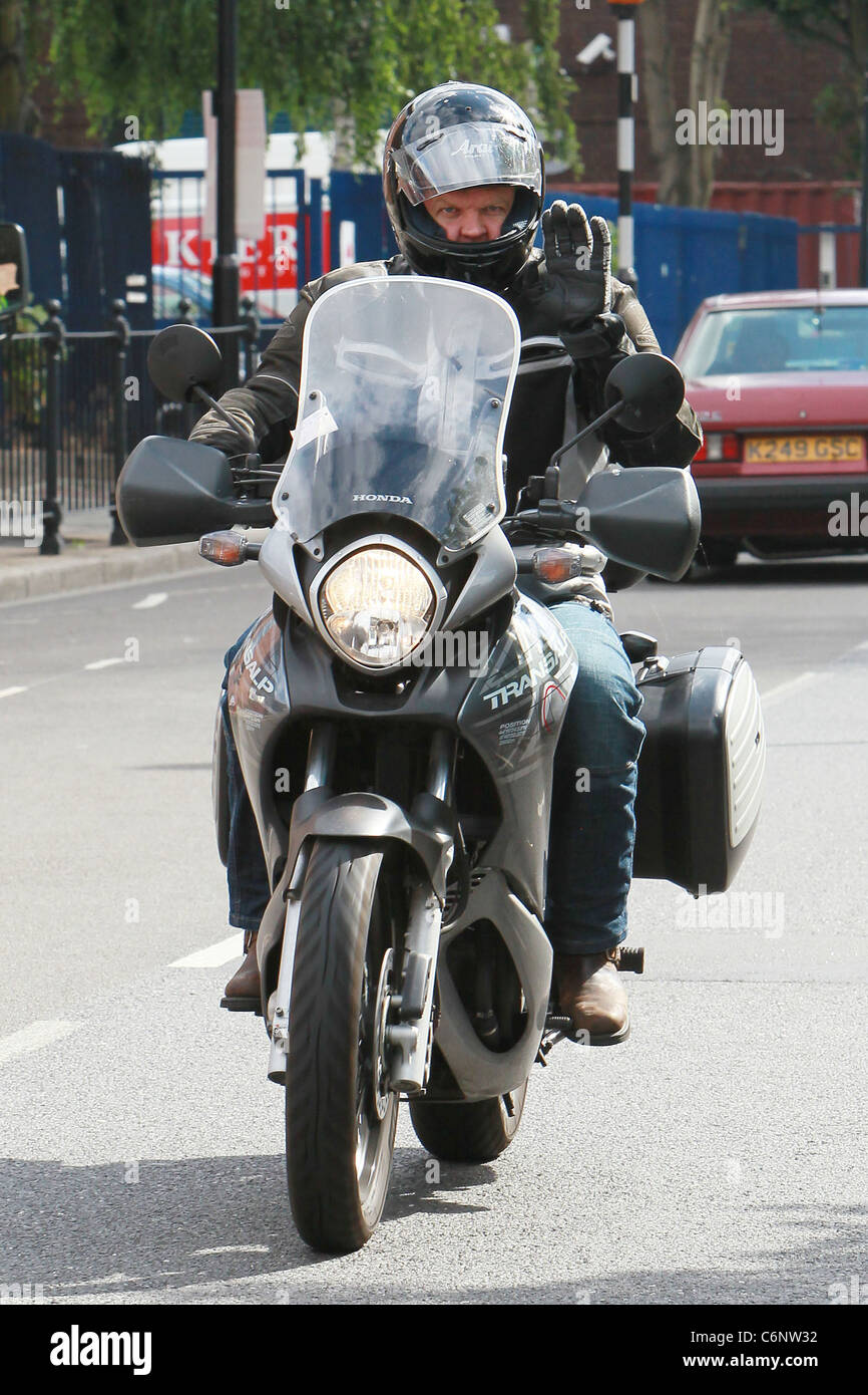 Adrian Chiles Arrives by motorcycle for a photo shoot at a studio in ...
