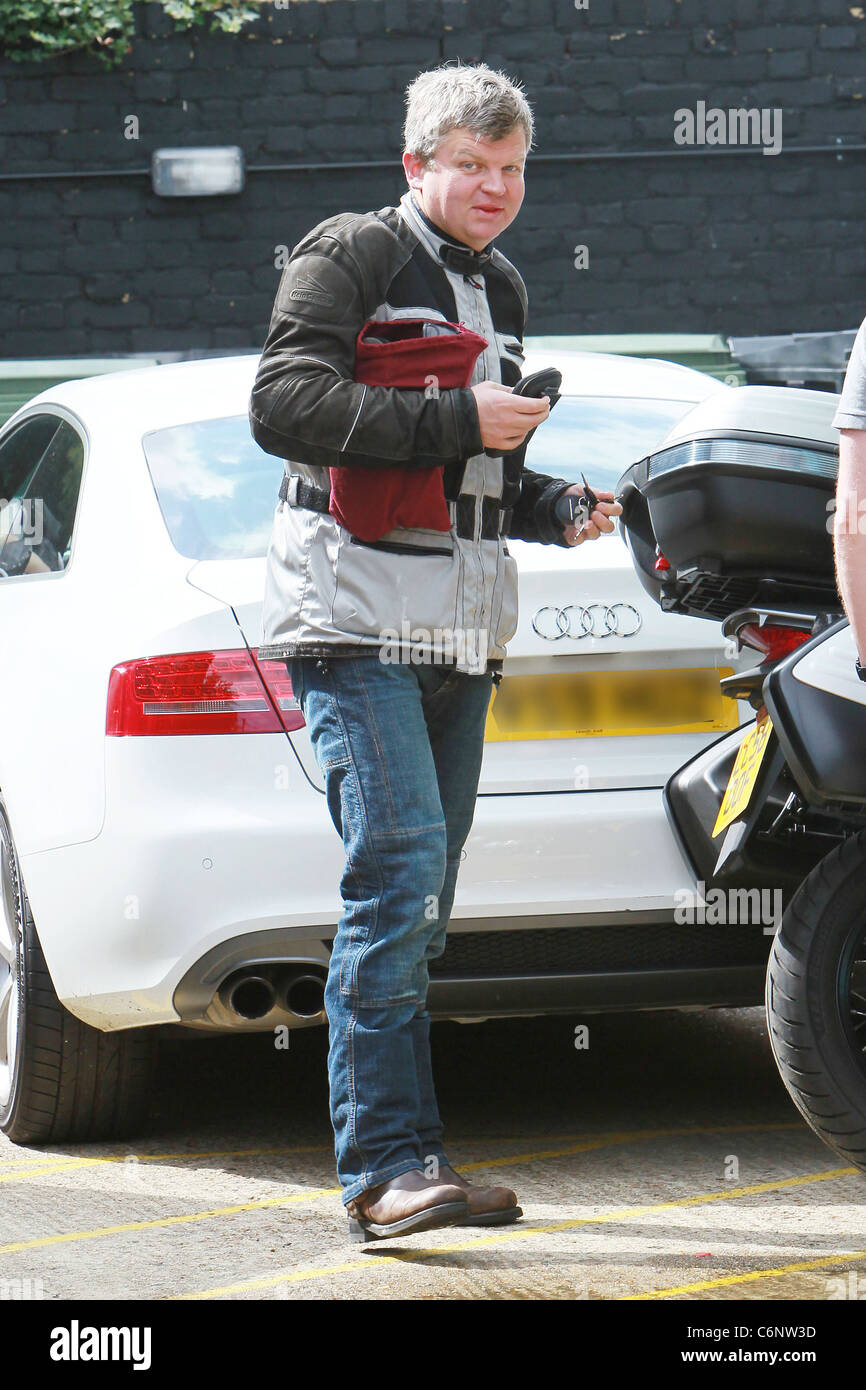 Adrian Chiles Arrives by motorcycle for a photo shoot at a studio in ...