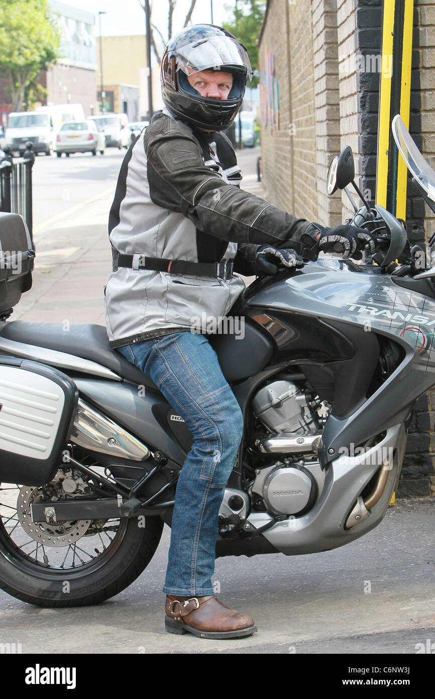 Adrian Chiles Arrives by motorcycle for a photo shoot at a studio in ...