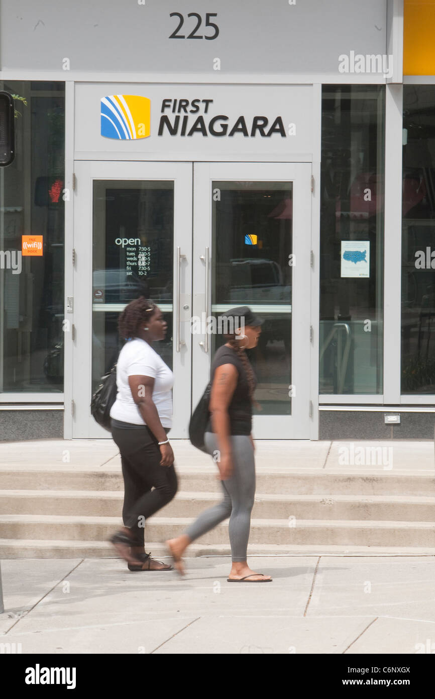 Two women walk by a branch of First Niagara bank in Hartford ...